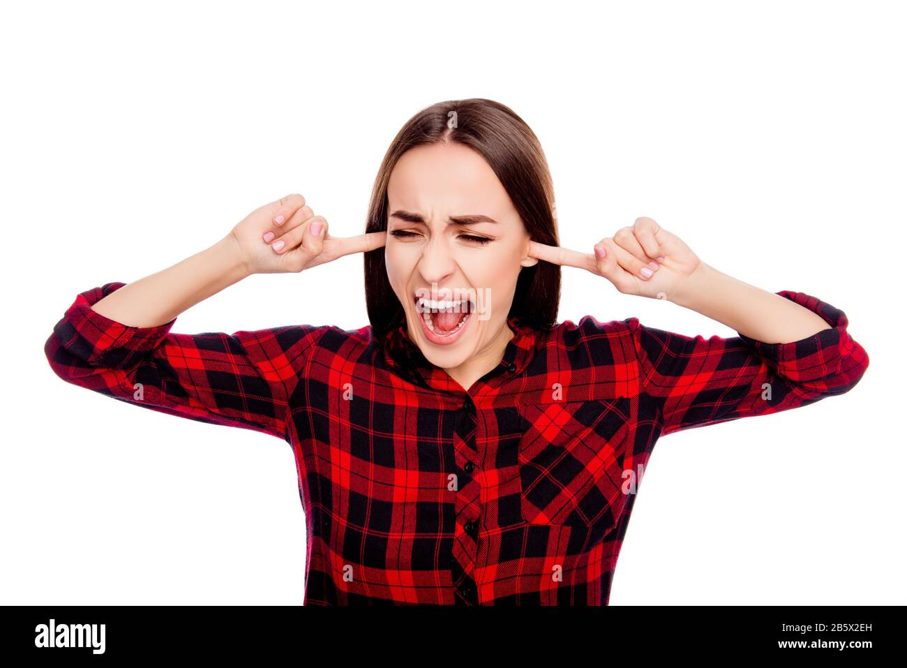 Angry upset woman covering ears with fingers and screaming Stock Photo ...