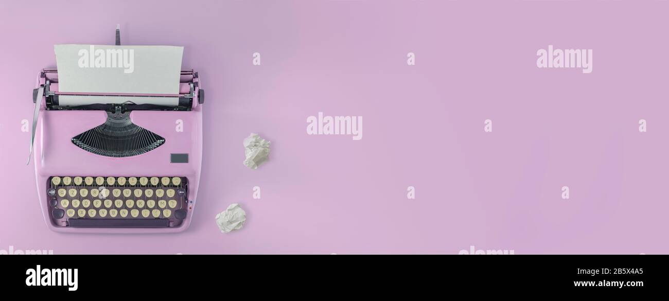 A pink vintage typewriter with pink background Stock Photo - Alamy