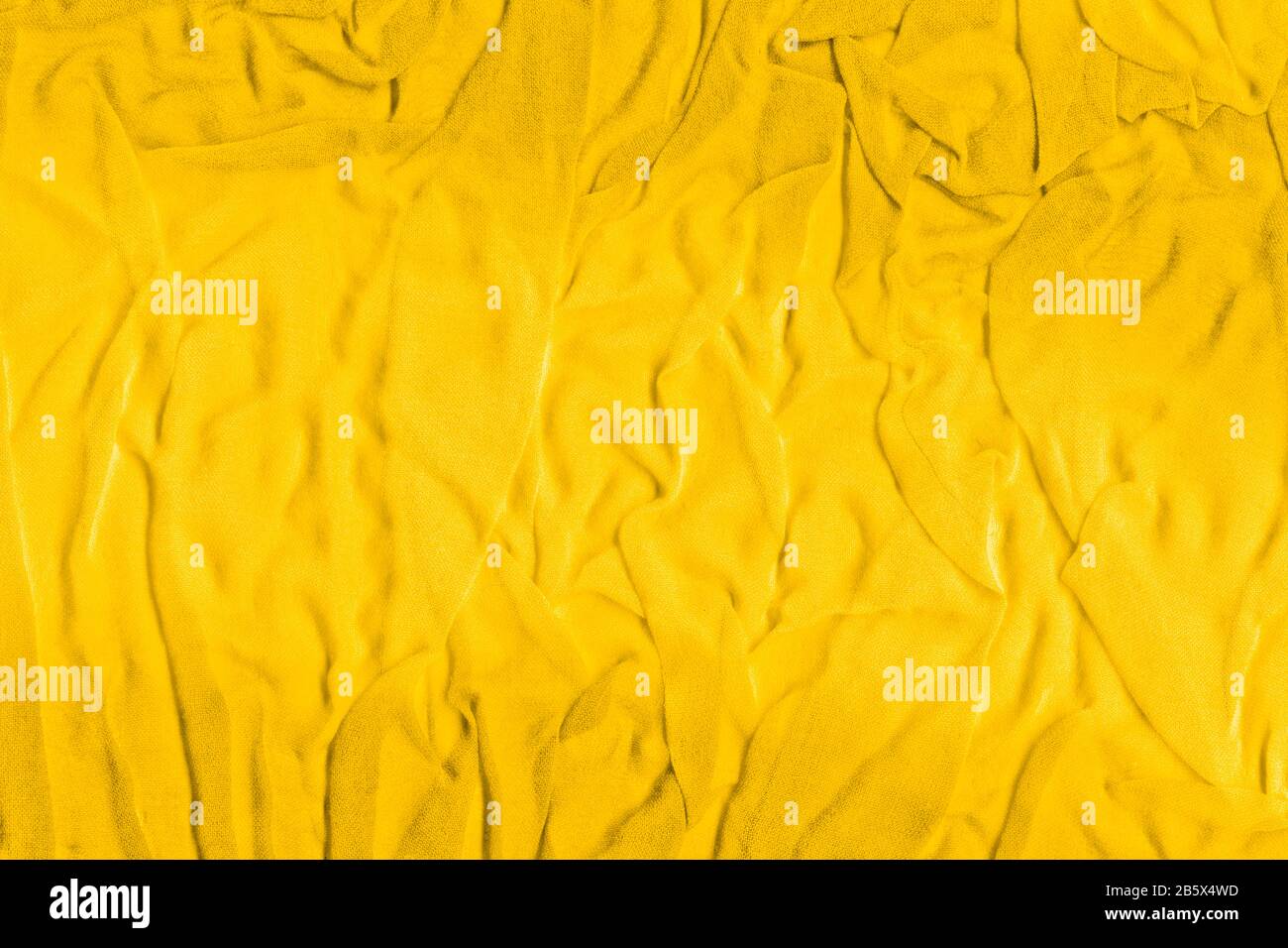 Vibrant yellow texture of binding crumpled fabric. Yellow textile ...