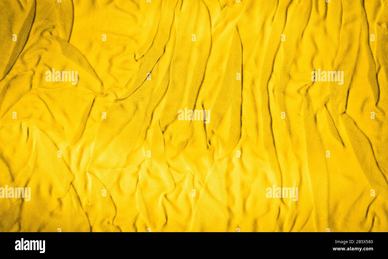 Vibrant yellow texture of binding crumpled fabric. Yellow textile ...