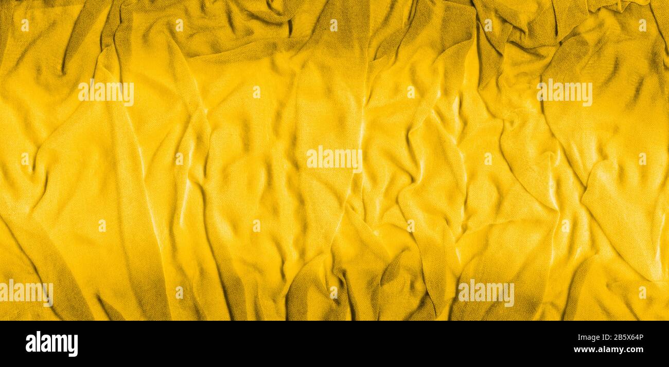 Vibrant yellow texture of binding crumpled fabric. Yellow textile ...