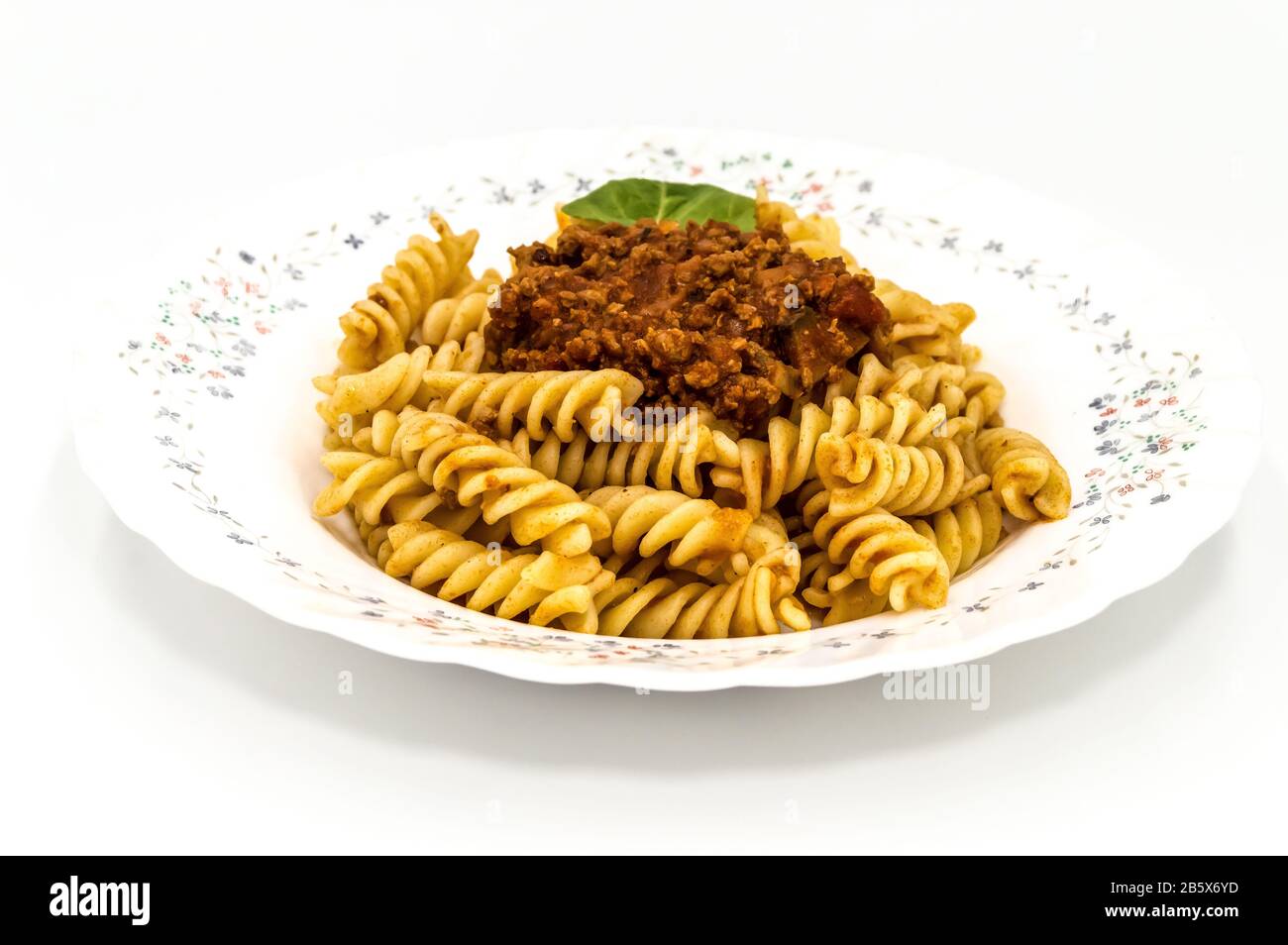Spirelli with Bolognese Sauce on a white background Stock Photo - Alamy