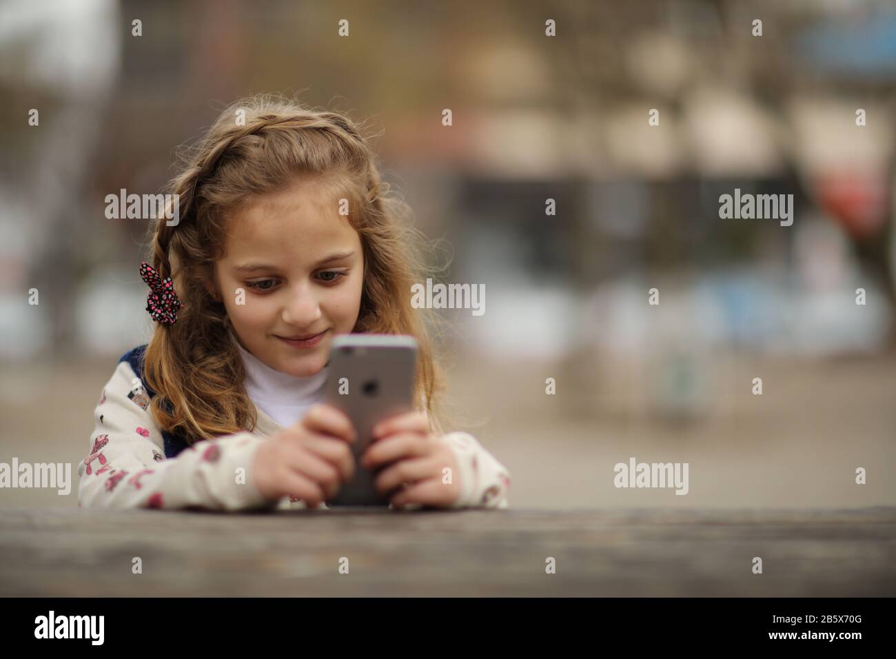 February 23, 2020: Children play with their smartphones and ipad in ...