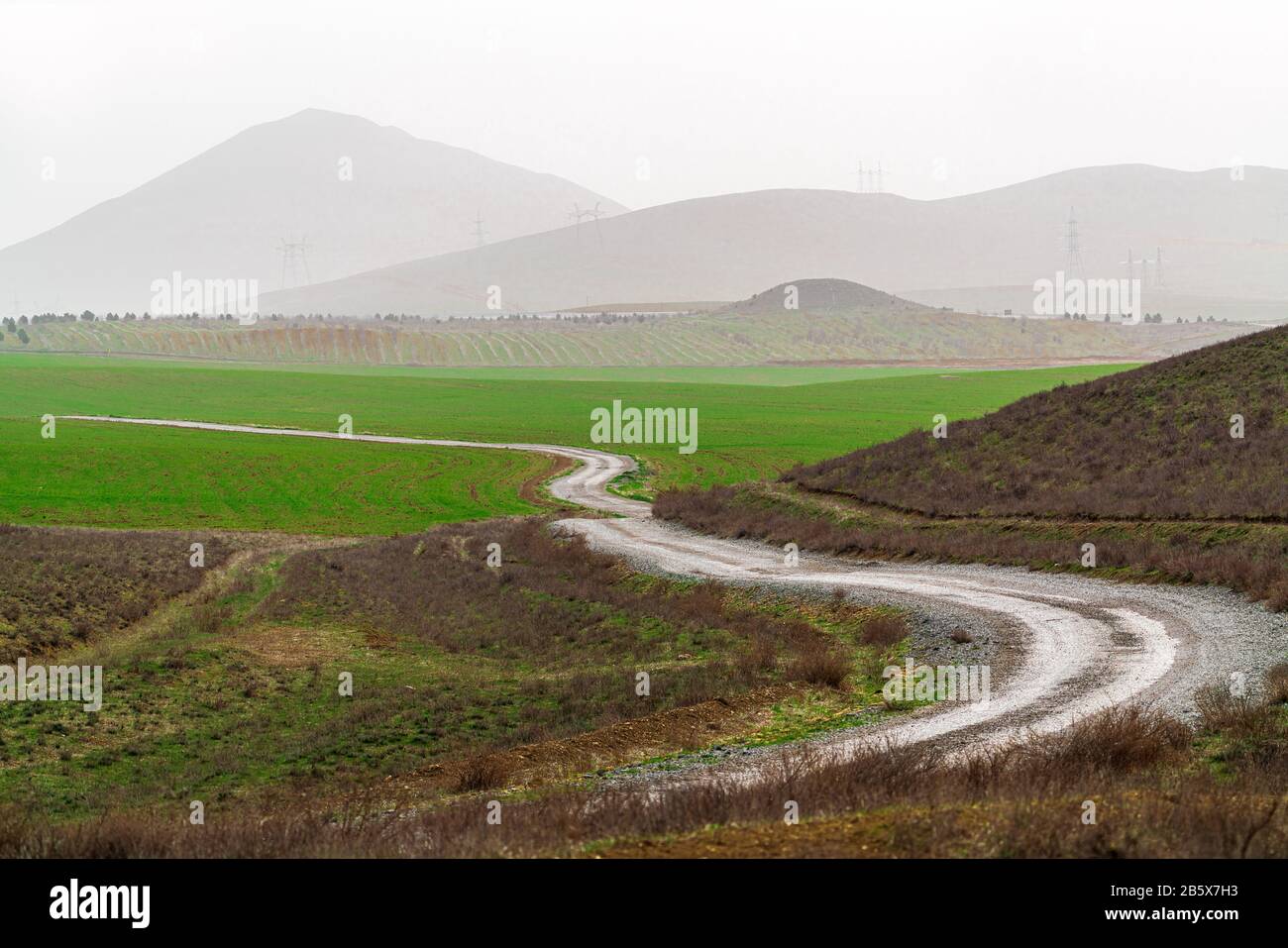 Winding dirt road in farm field Stock Photo - Alamy