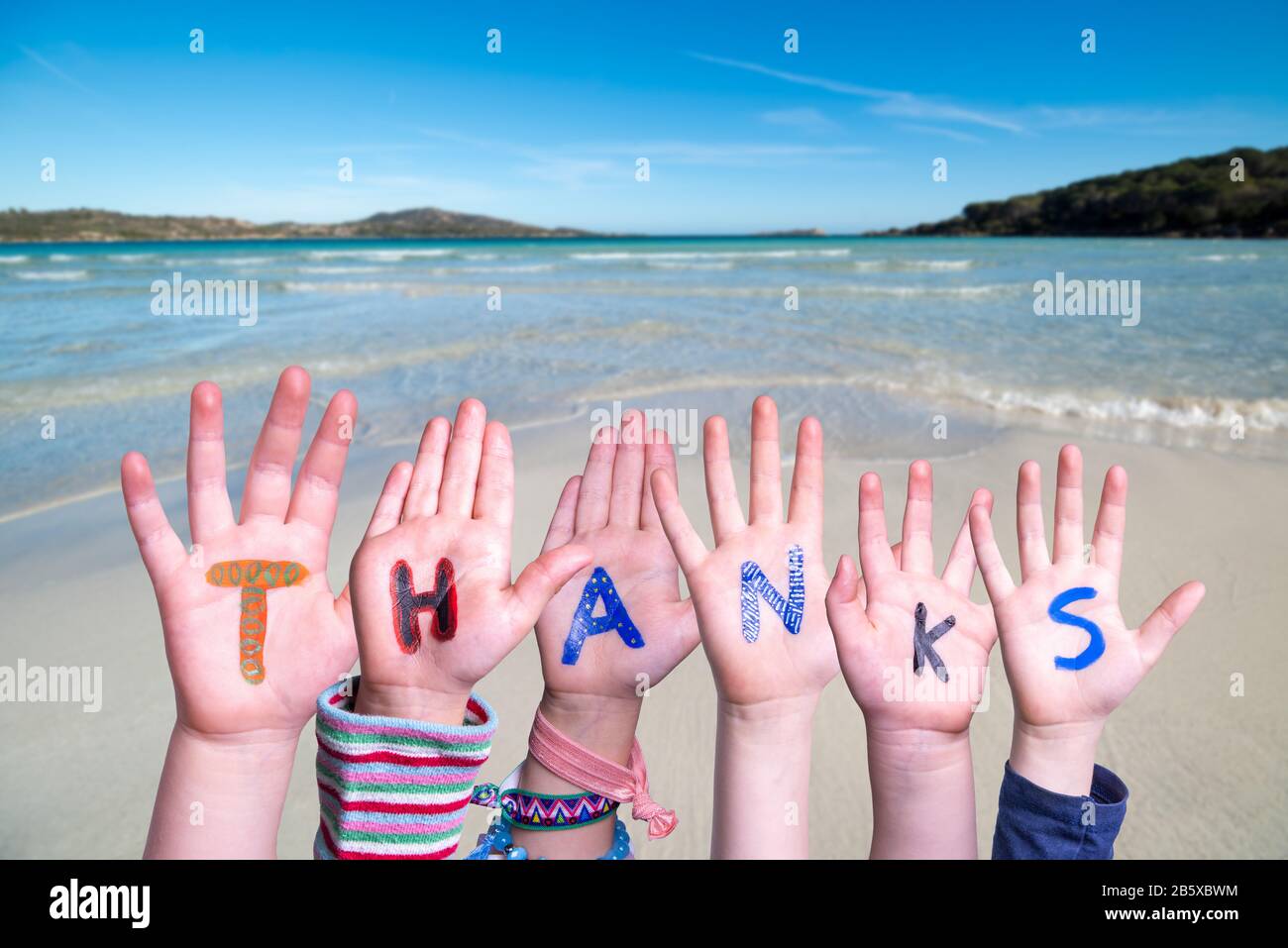 Children Hands Building Word Thanks, Ocean Background Stock Photo - Alamy