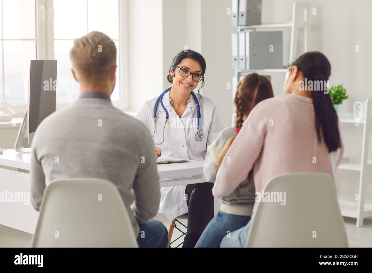 Happy family on a visit to the doctor in the office of a doctor Stock ...