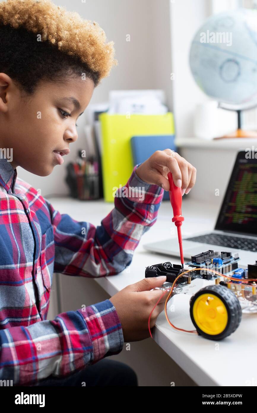 Male Elementary School Pupil Building Robot Car In Science Lesson Stock ...