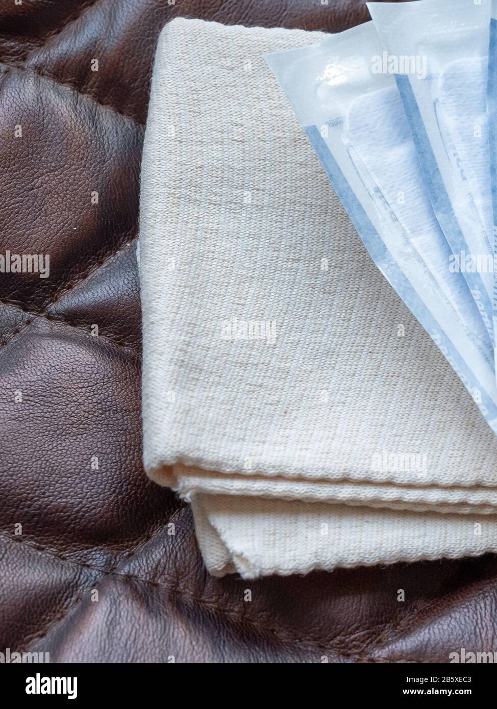 packaged gauze pads and bandage on brown background, concept of ...