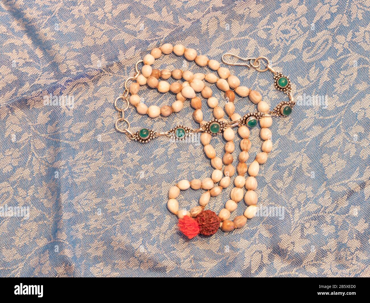 a pebble colored Indian necklace on a indian scarf Stock Photo - Alamy
