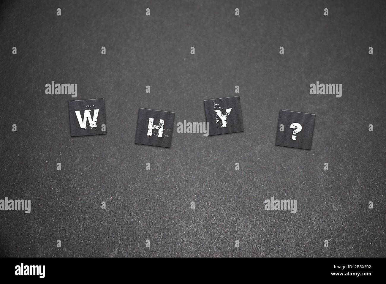 Close up of scratched letters that spell out WHY with question mark on ...