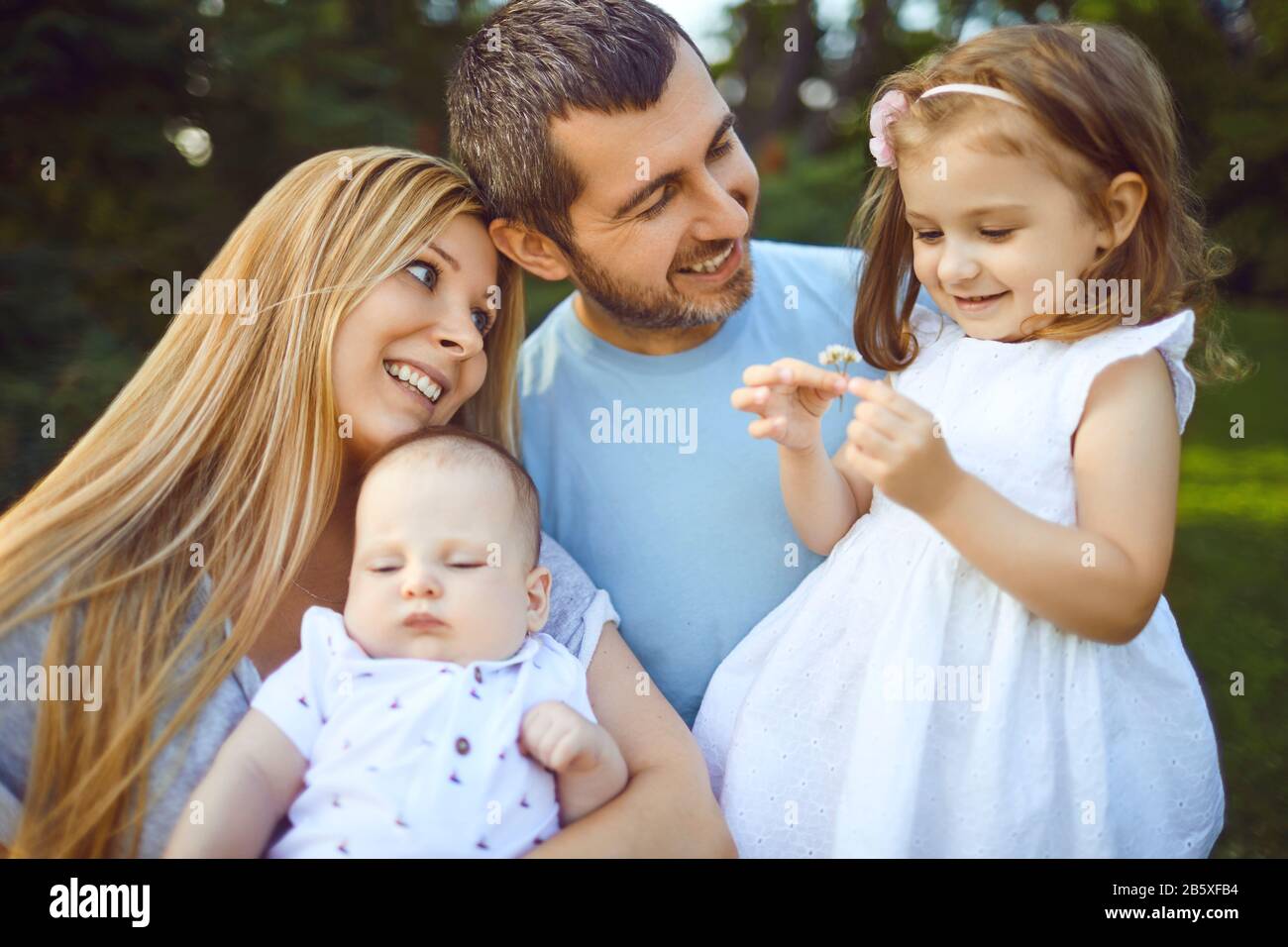 Mother father and children funny laughing outside Stock Photo - Alamy
