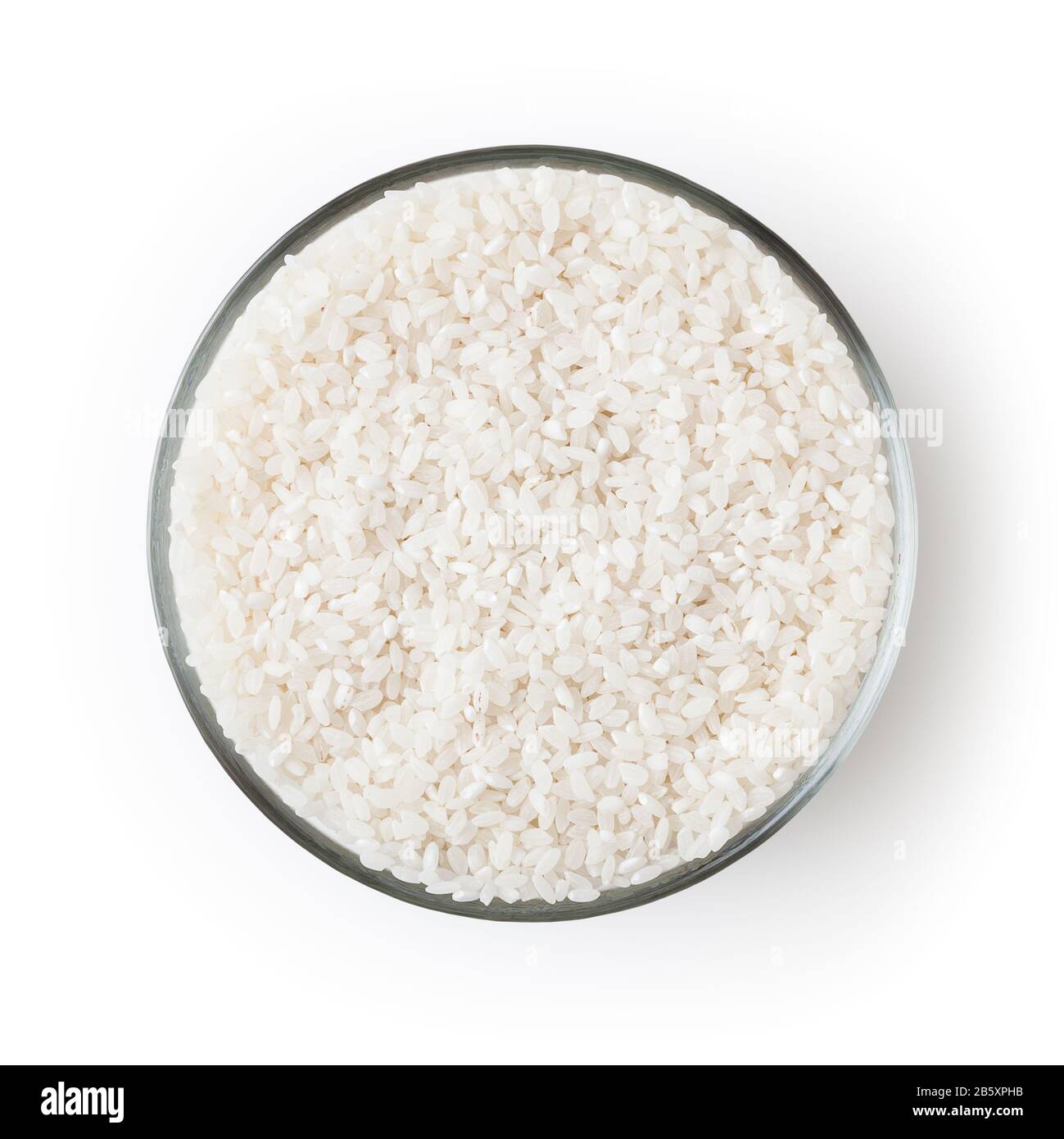 Uncooked round rice in glass bowl isolated on white background with ...