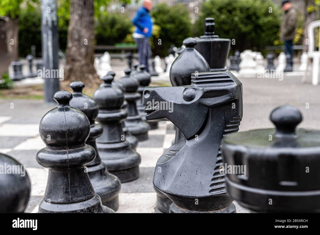Outdoor chess board with big plastic pieces. Outdoor giant chess in ...