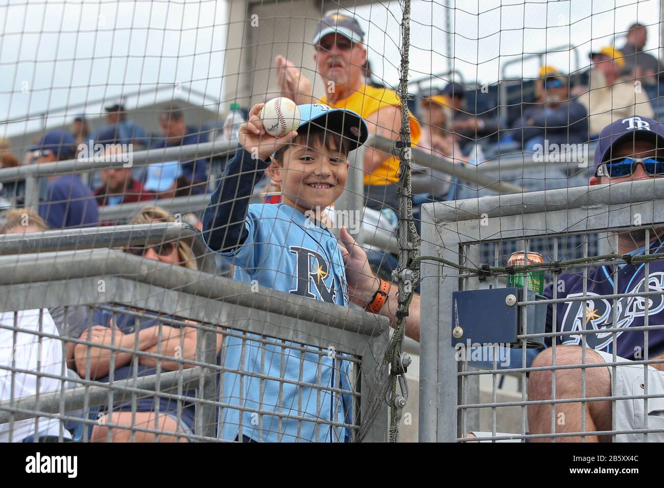 A young Tampa Bay Rays fan receives a ball during a spring training ...