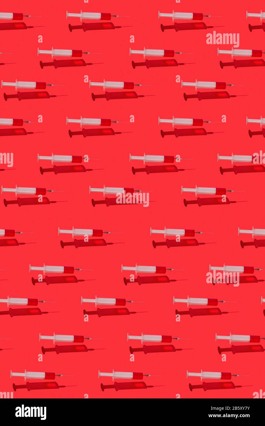 Medicinal pattern of flying syringes with red blood or vaccine Stock ...