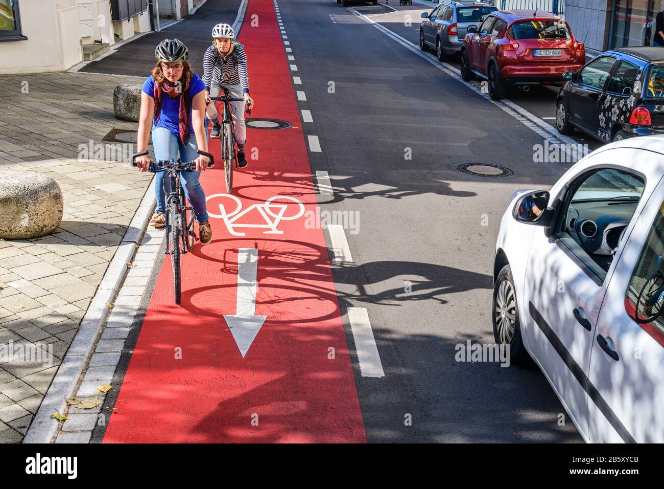 Cyclists using special cycling road on one-way-street Stock Photo - Alamy