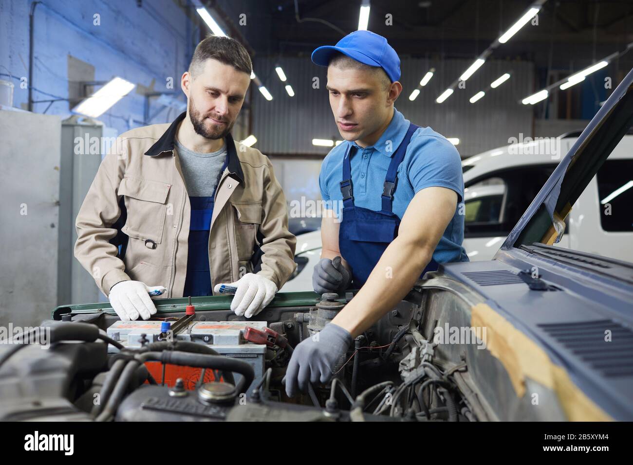 Horizontal medium shot of two young adult Caucasian men wearing uniform ...