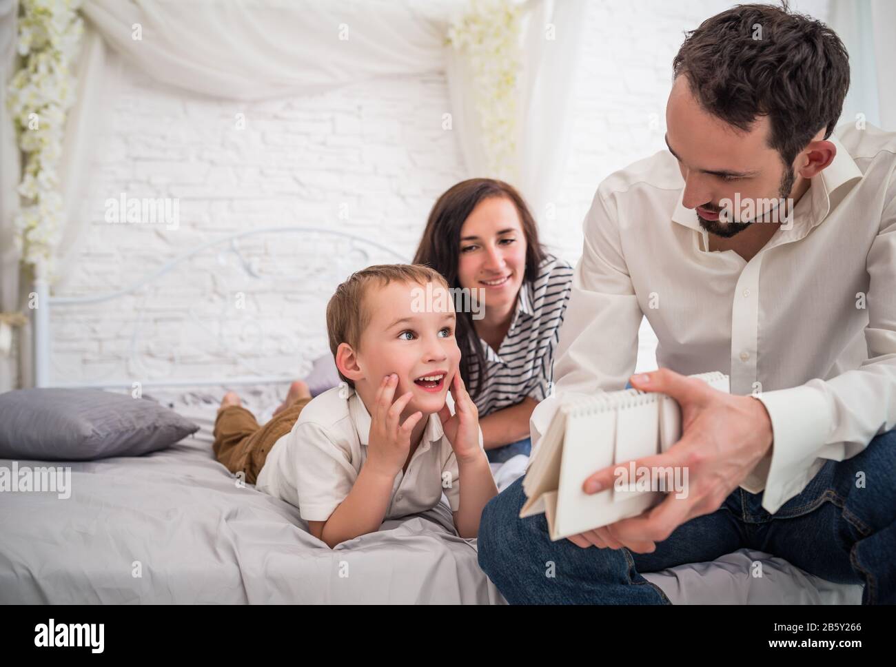 Charming mom and positive dad with a calendar in his hands talking with ...
