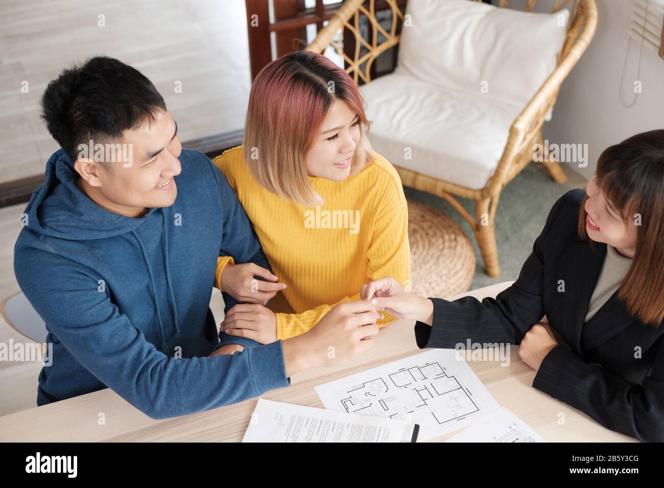 Asian happy couple getting key and handshake with realtor agent with ...
