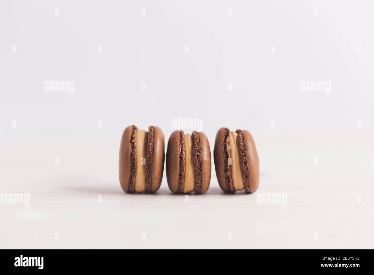 Tasty french macarons on a white background. Chocolate macarons with ...