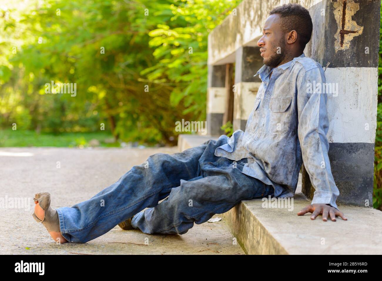 Young homeless African man on the bridge Stock Photo - Alamy