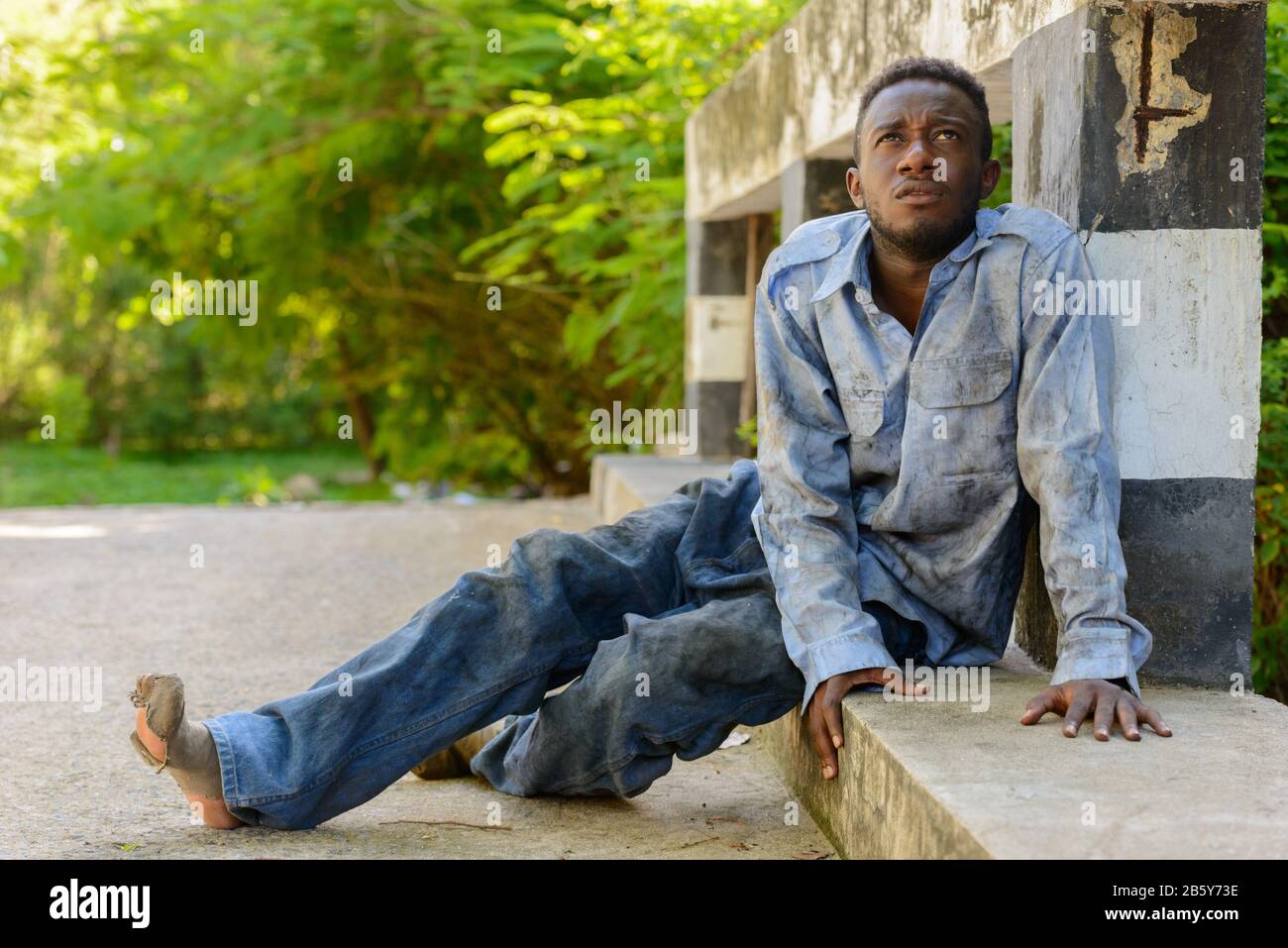 Young homeless African man on the bridge Stock Photo - Alamy