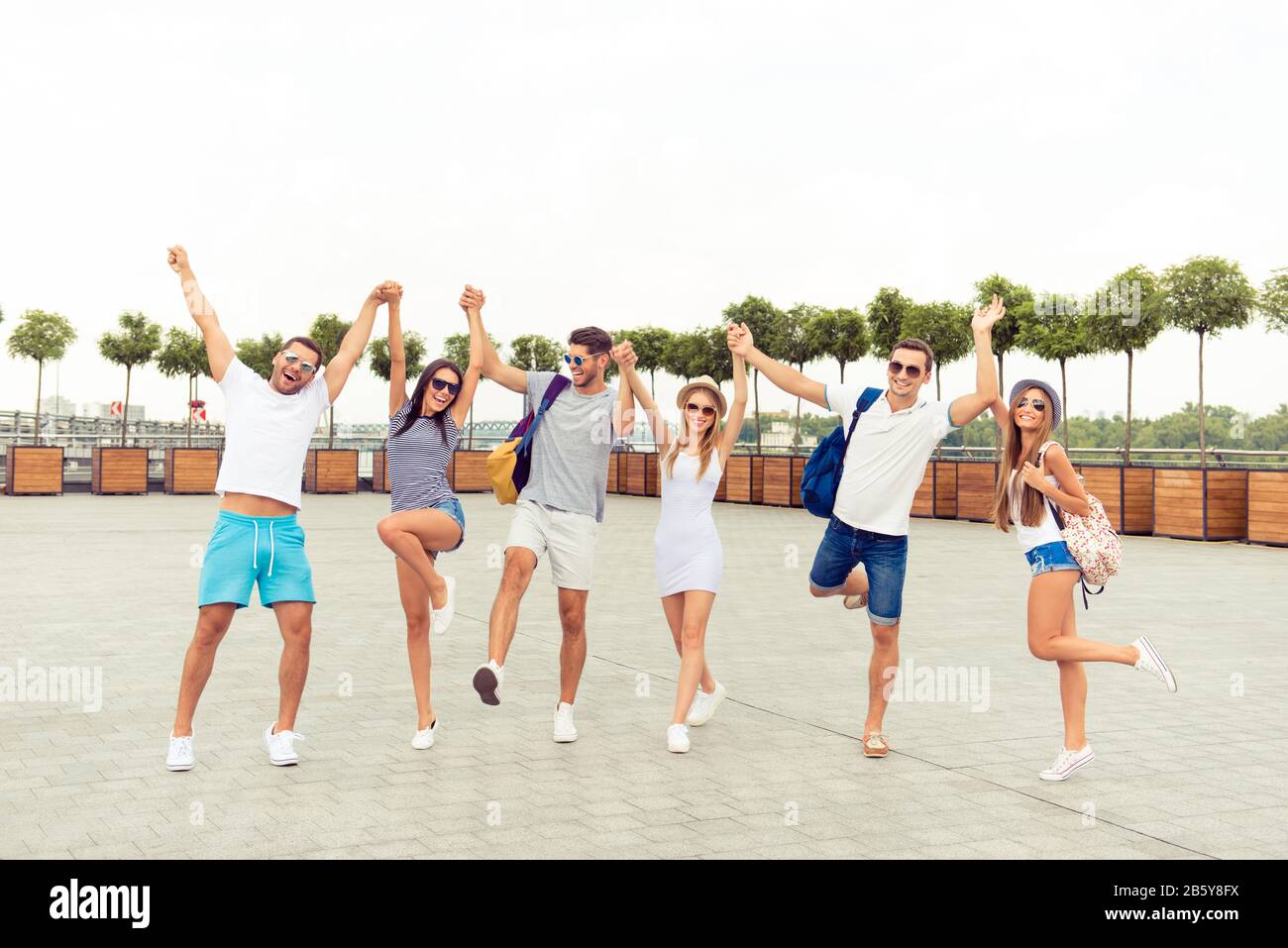 joyful happy young people having fun and walking square of city Stock ...