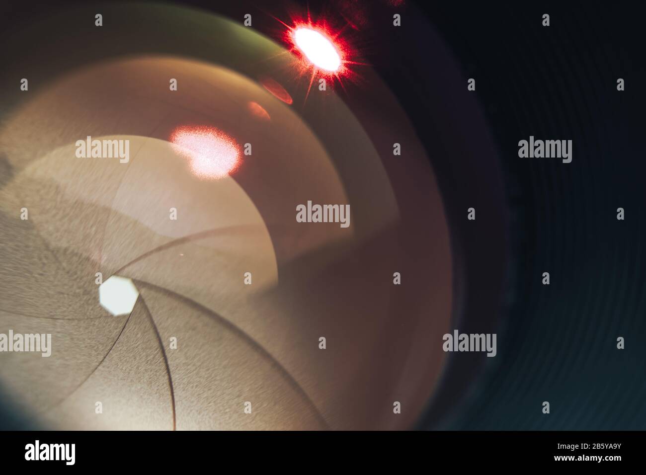 Beautiful camera lens with yellow and red light of glass. Background ...