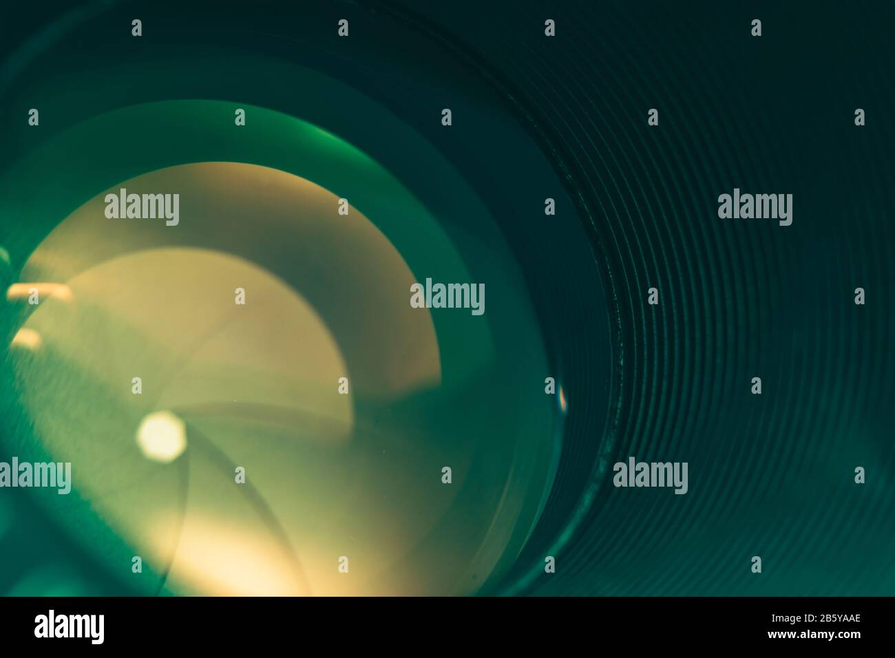 Beautiful camera lens with green light of glass. Background pattern for ...