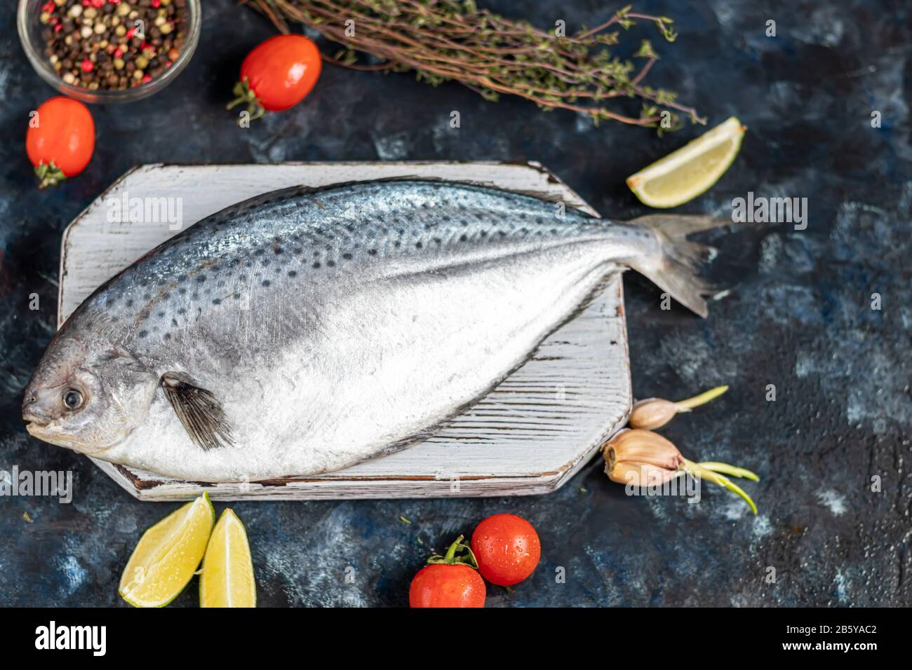 Sea tasty fresh fish on a dark background. Frozen product. Fish with ...
