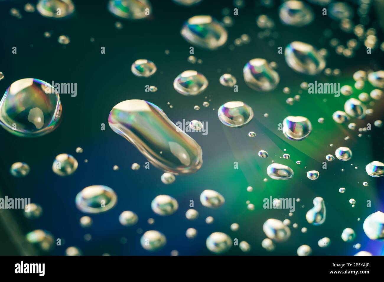 Close up beautiful abstract multi colored water drop of holographic ...