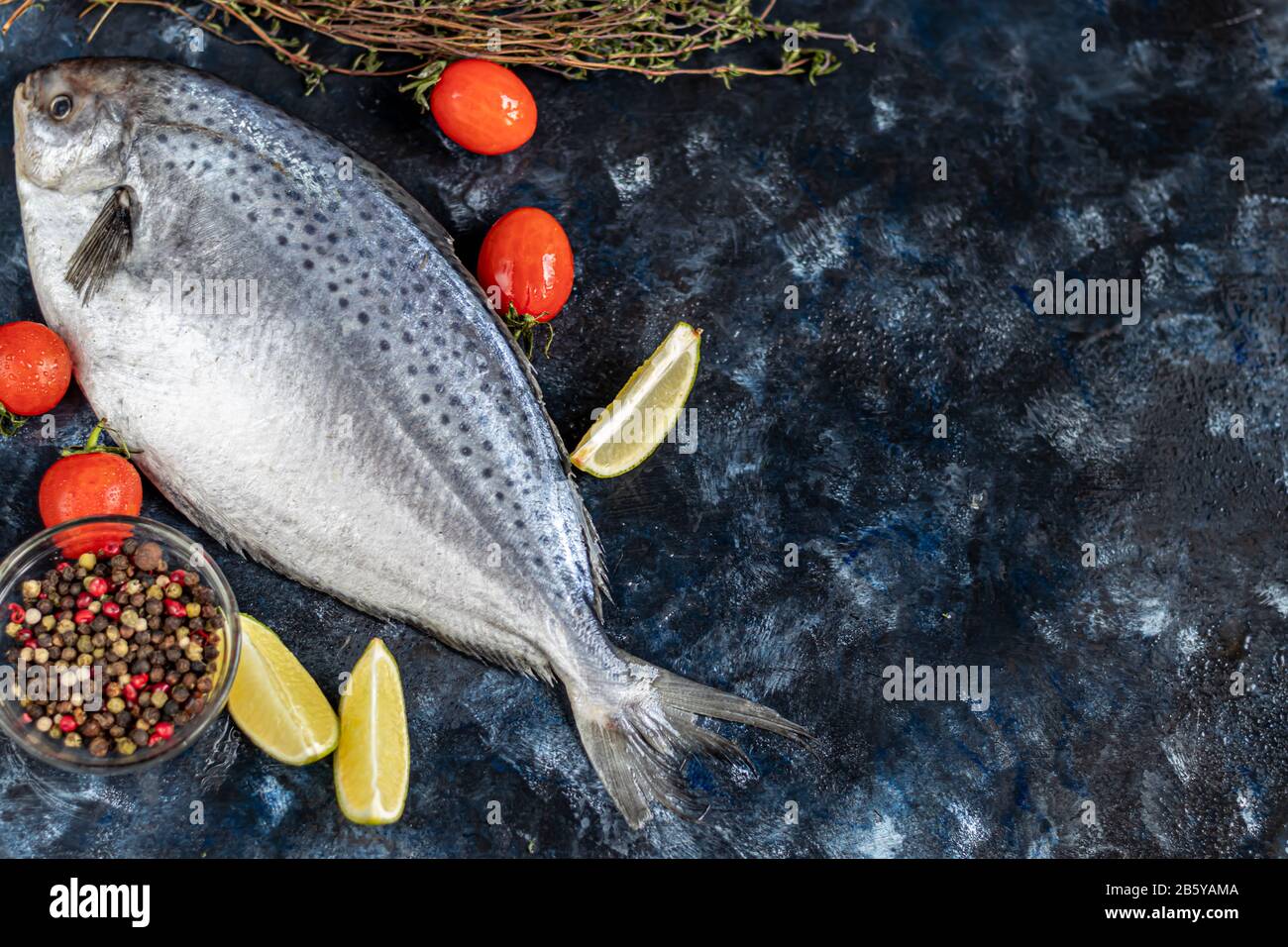 Sea tasty fresh fish on a dark background. Frozen product. Fish with ...