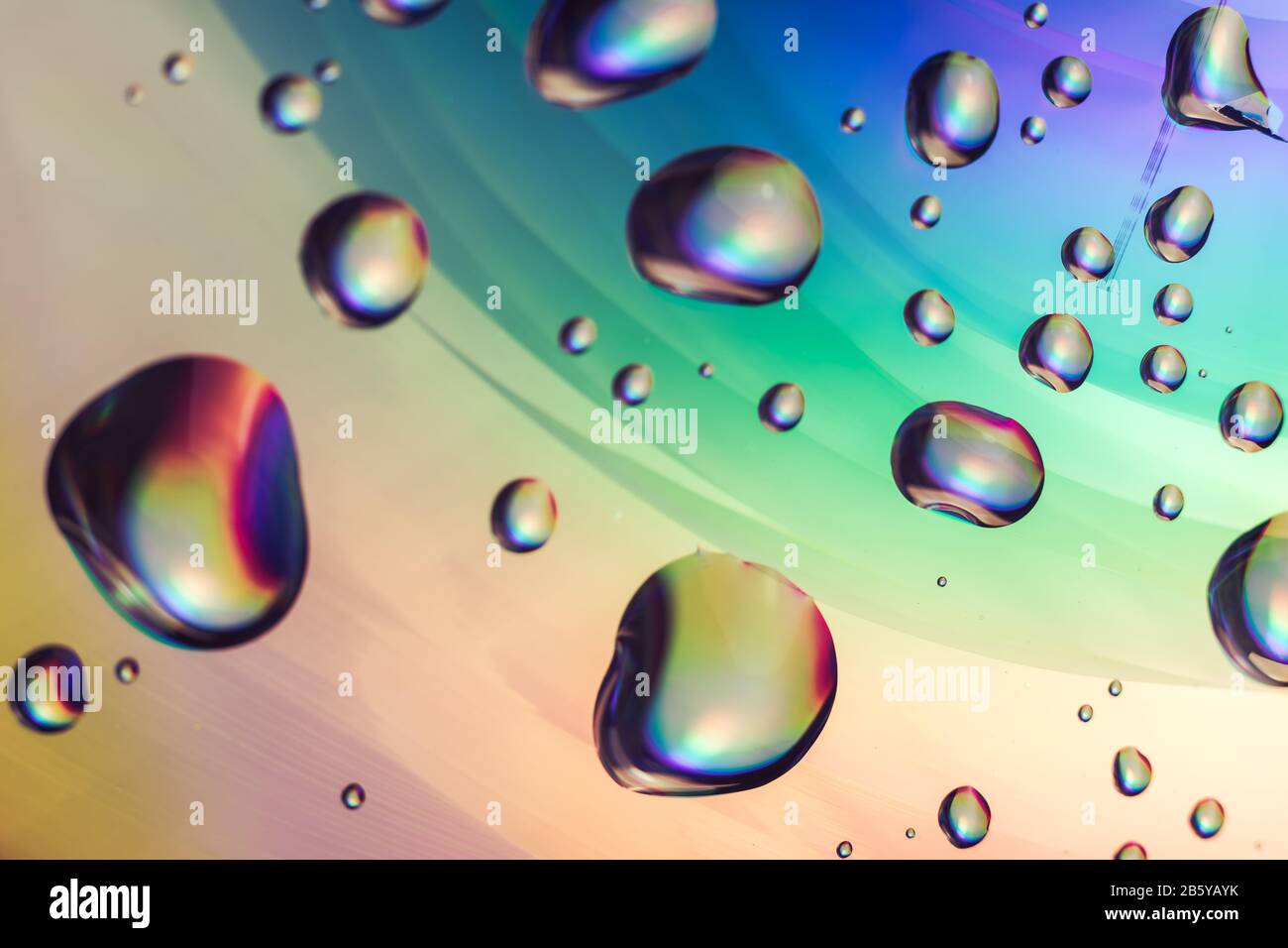 Close up beautiful abstract multi colored water drop of holographic ...