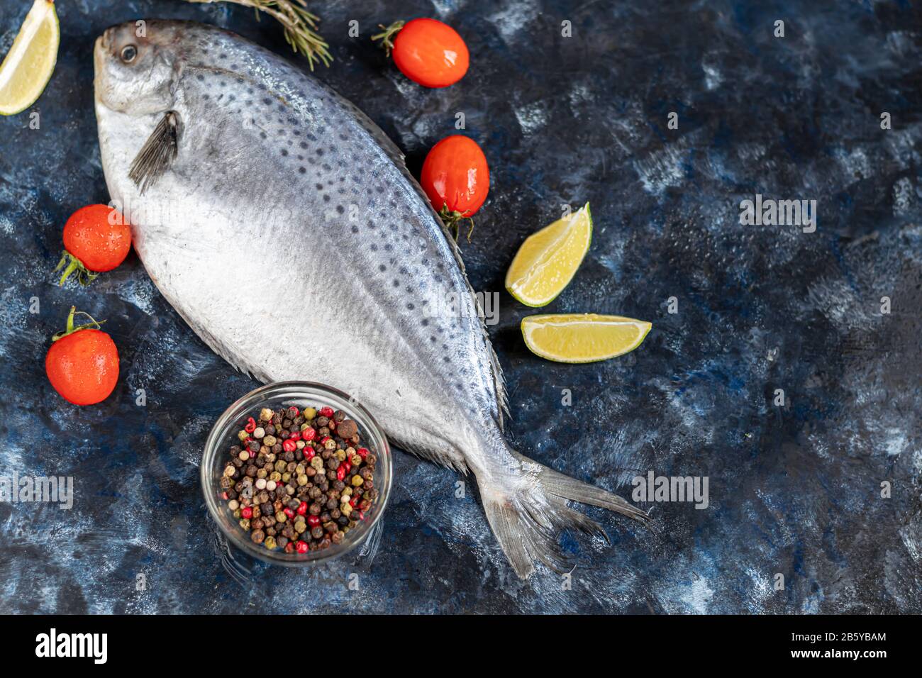 Sea tasty fresh fish on a dark background. Frozen product. Fish with ...
