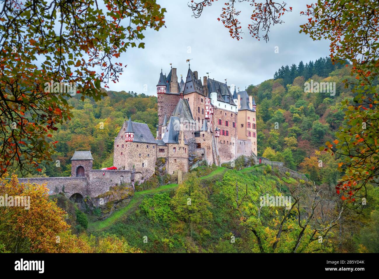 Eltz Castle in autumn - famous hilltop castle nested in the forest ...
