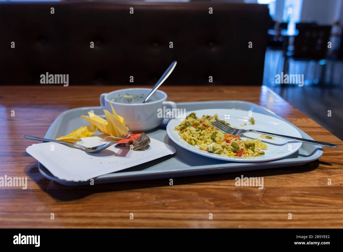 remnants of food on the tray, the remains of lunch. Rice with ...