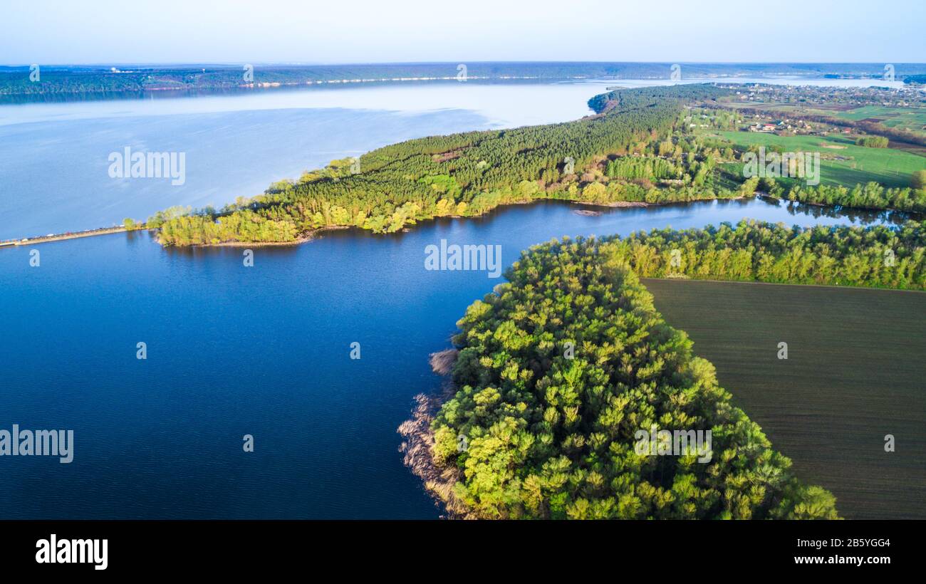 Aerial: Flying over a lake with sun illuminating the water Stock Photo ...