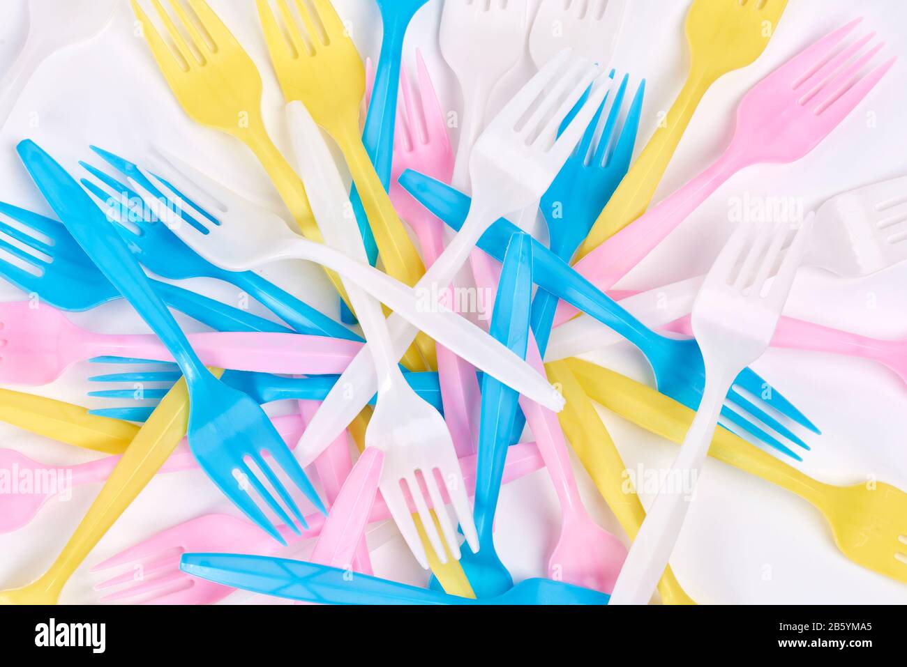 Colored, plastic forks on white background Stock Photo - Alamy