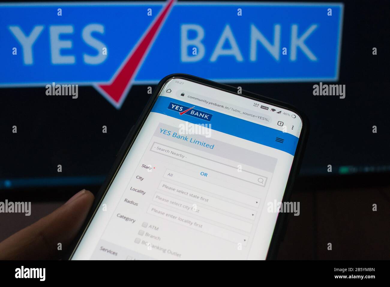 A mobile logged into the yes bank mobile application infront of the yes ...