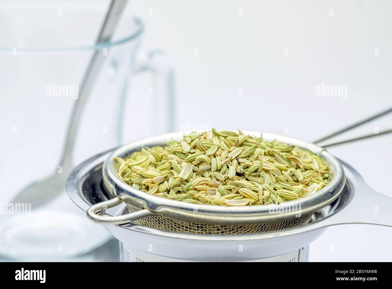 fennel seeds loose inside sieve ready to be brewed for healthy drink on ...