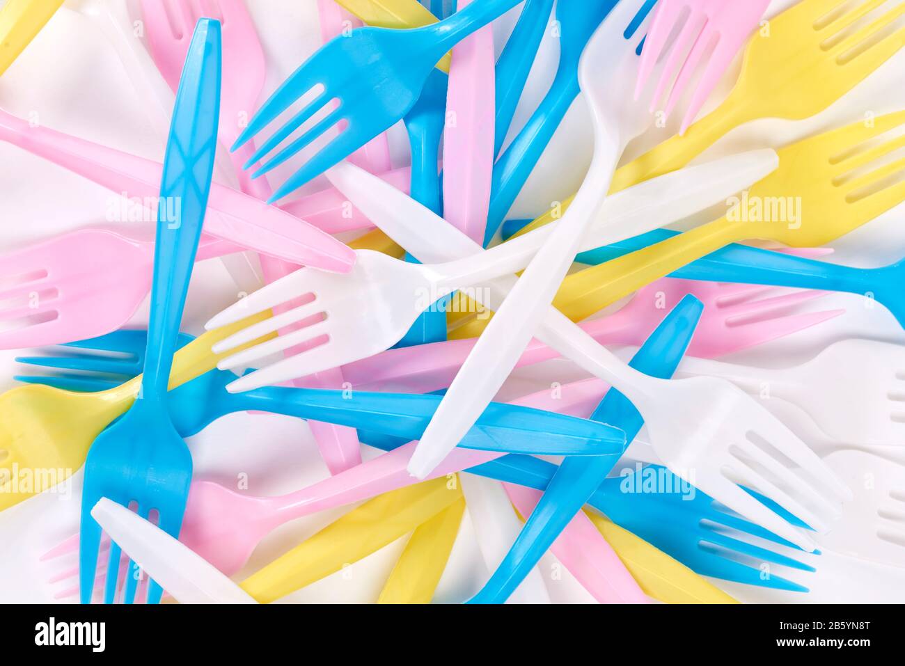 Colored, plastic forks on white background Stock Photo - Alamy
