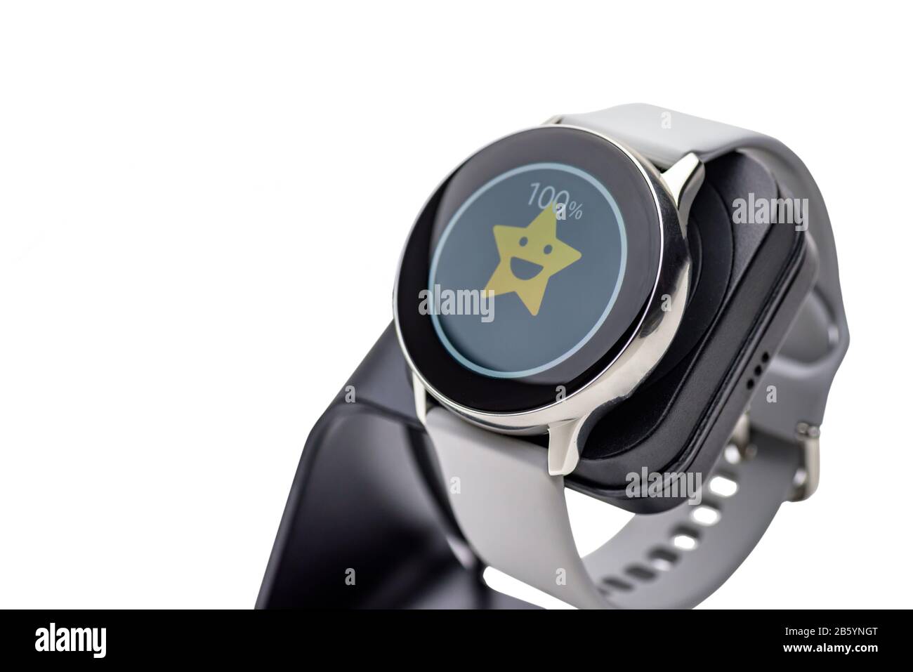 smart watch charging on wireless charging stand pad on white background ...