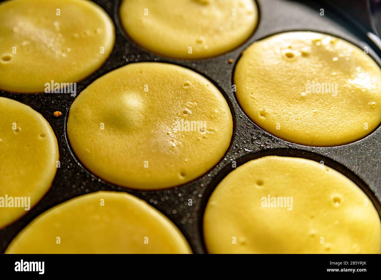 pancake frying pan with smile face pancake cooking on cooker in kitchen ...