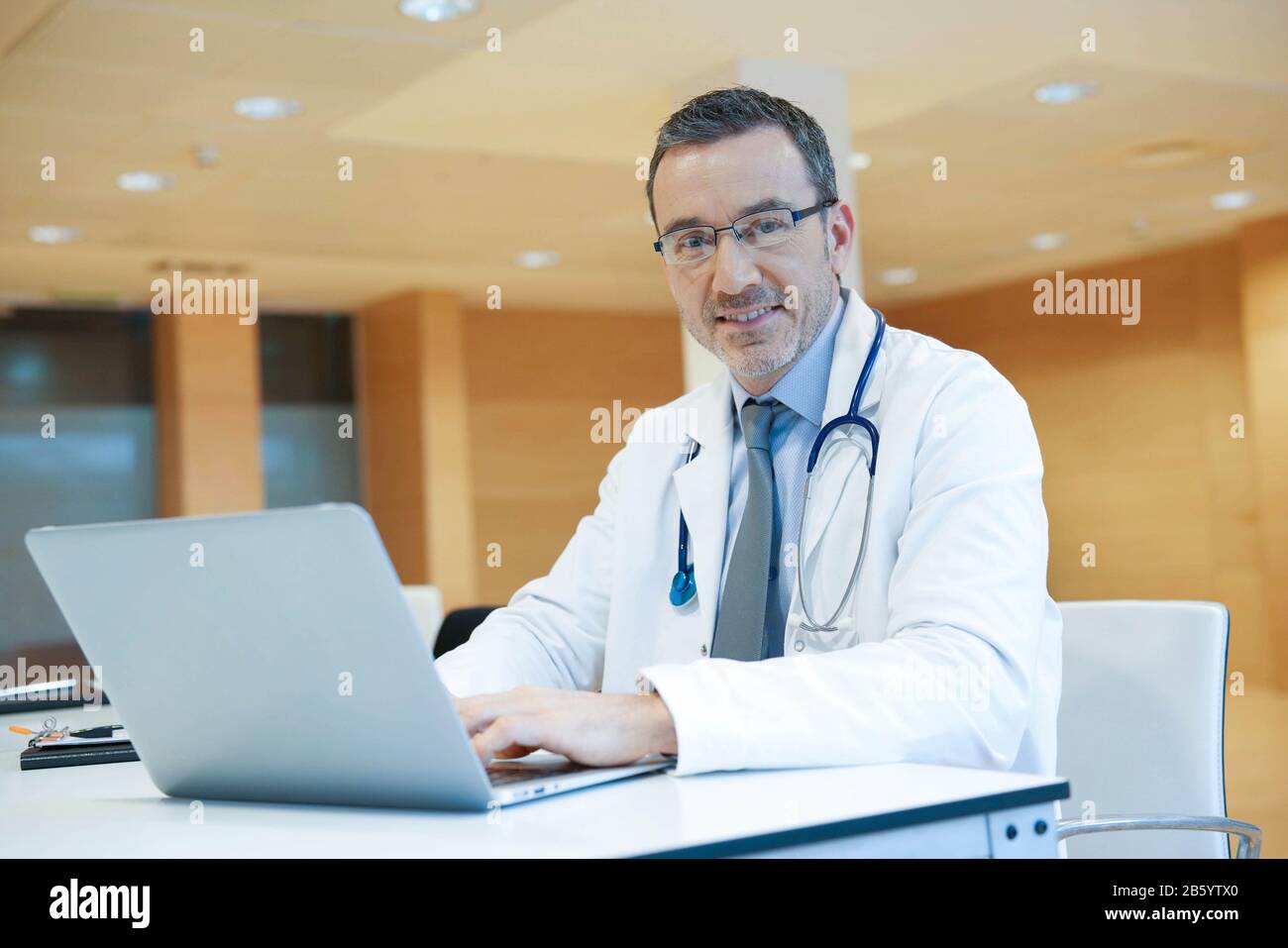 Portrait of doctor at work, smiling to camera Stock Photo - Alamy