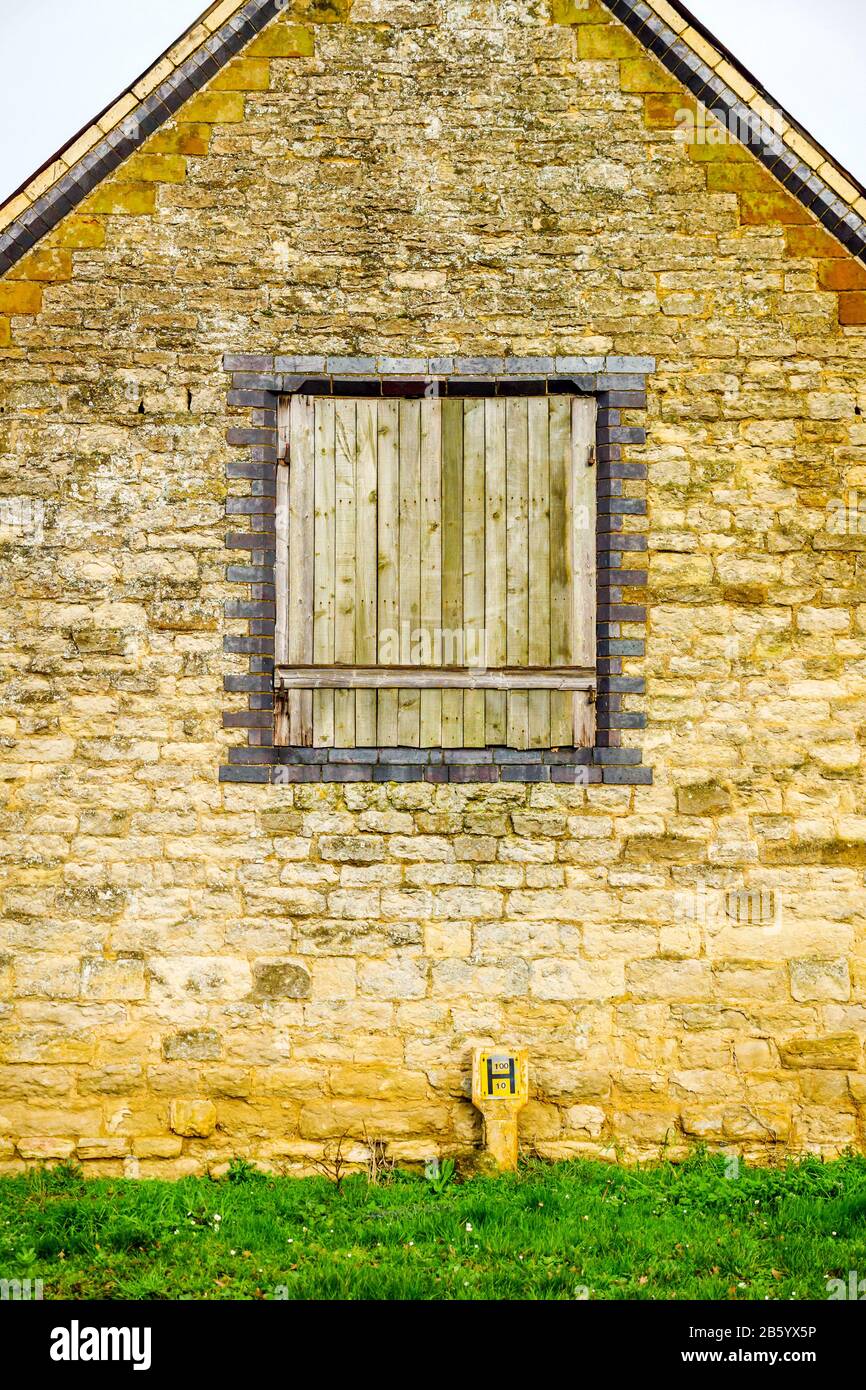 old window on stone wall building texture in england uk Stock Photo - Alamy