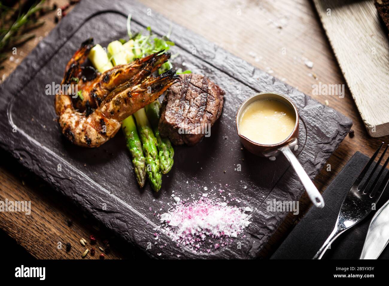 Tasting menu. Beef steak and grilled tiger prawns Stock Photo - Alamy