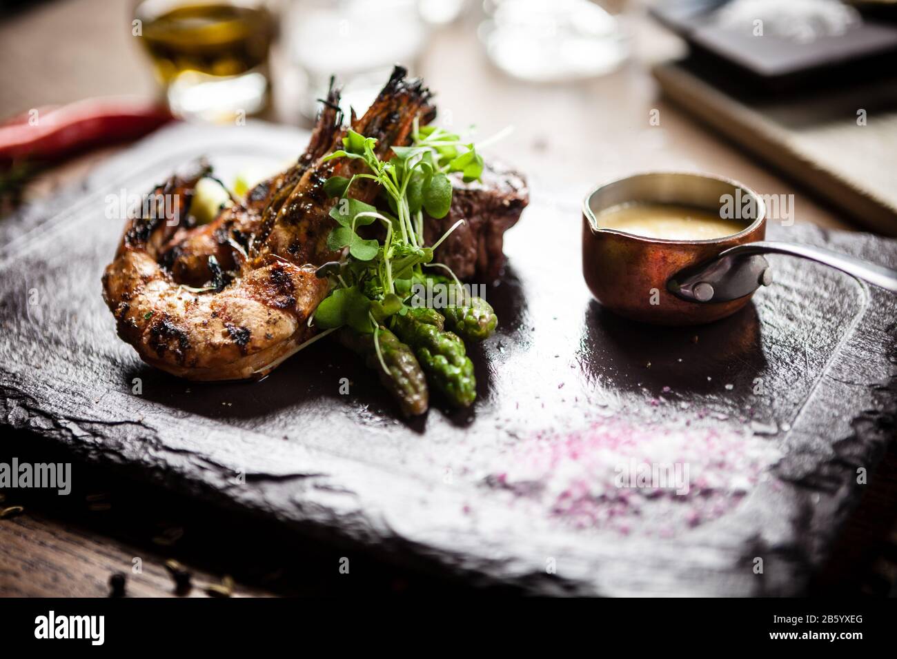Tasting menu. Beef steak and grilled tiger prawns Stock Photo - Alamy