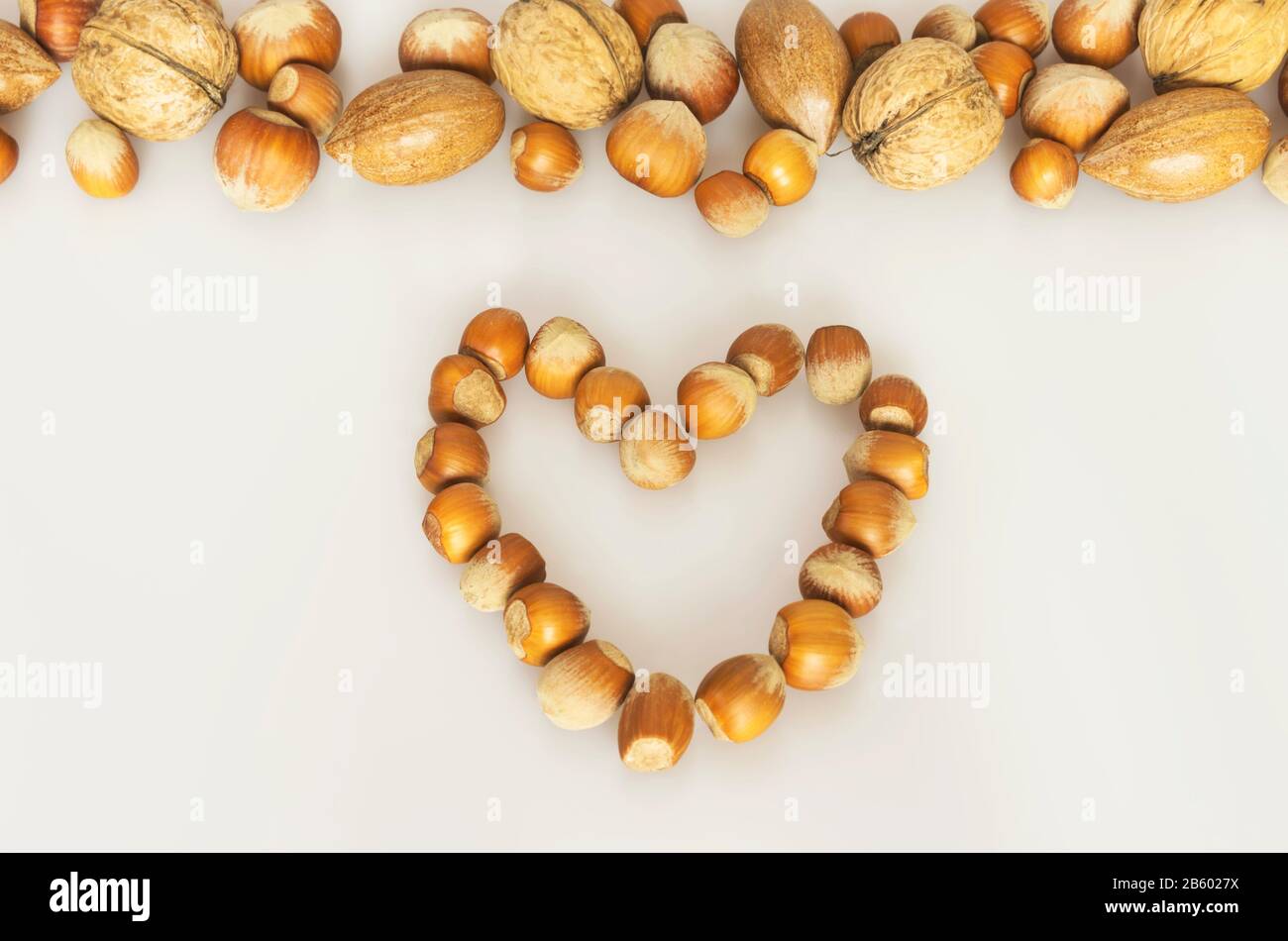 heart of nuts on white background Stock Photo - Alamy
