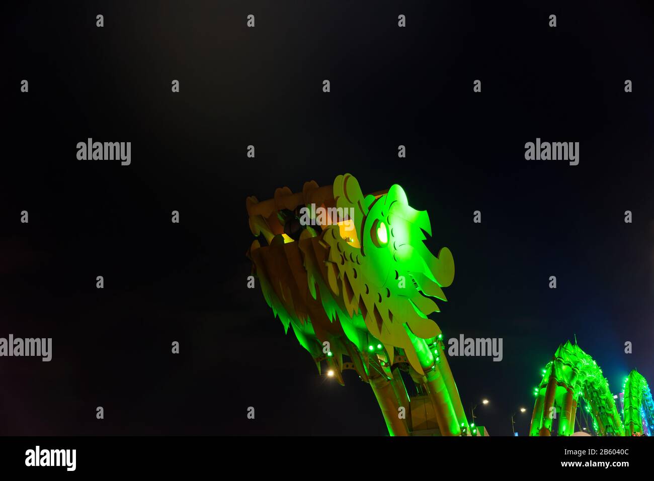 Low angle view of the Dragon head in green lights. Dragon bridge in Da ...
