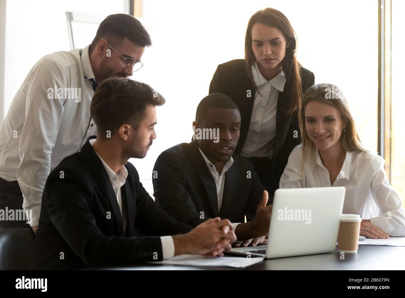 Group of employees listening to focused african american manager Stock ...